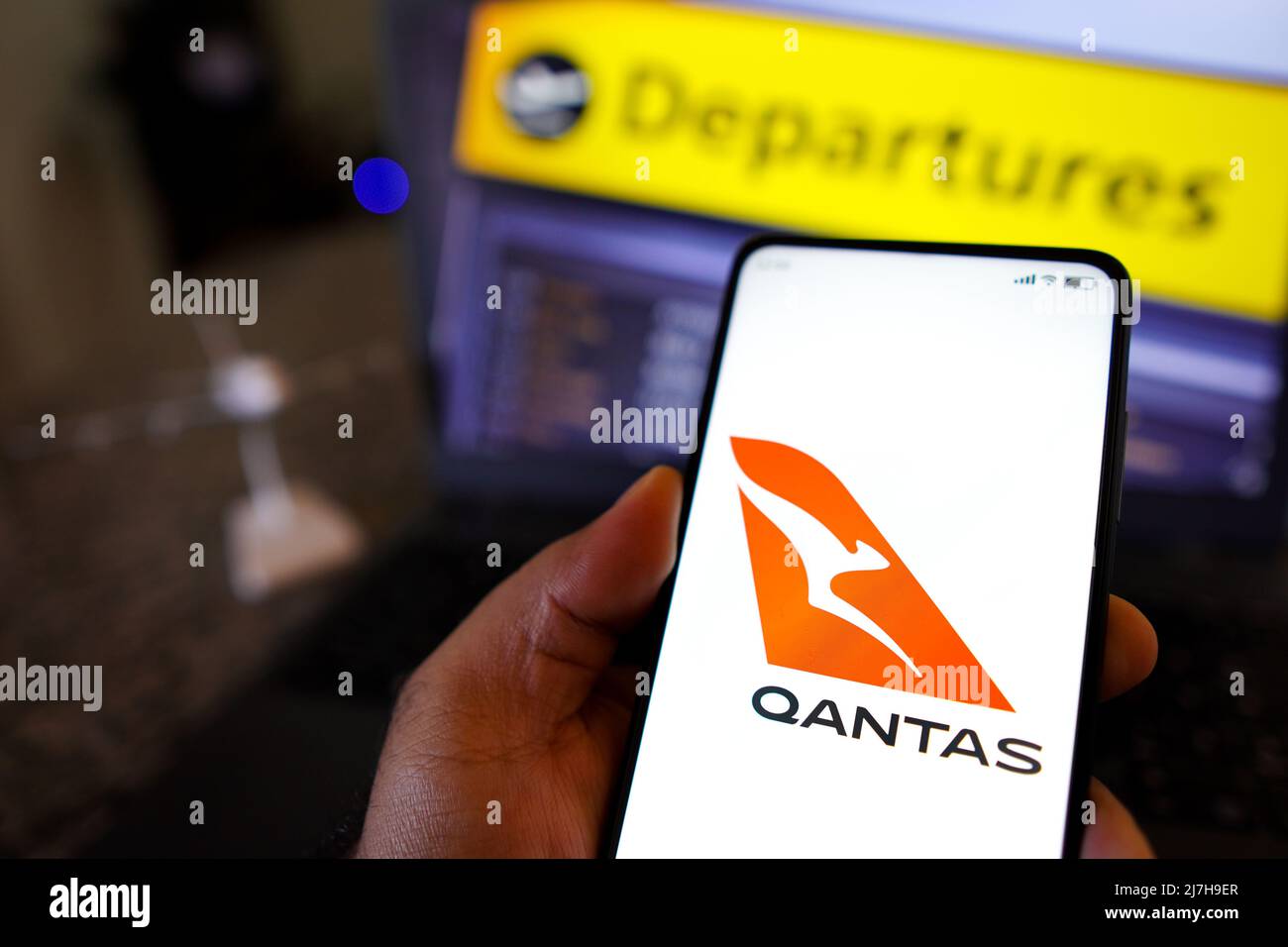 In this photo illustration, the Qantas Airways logo seen displayed on a ...