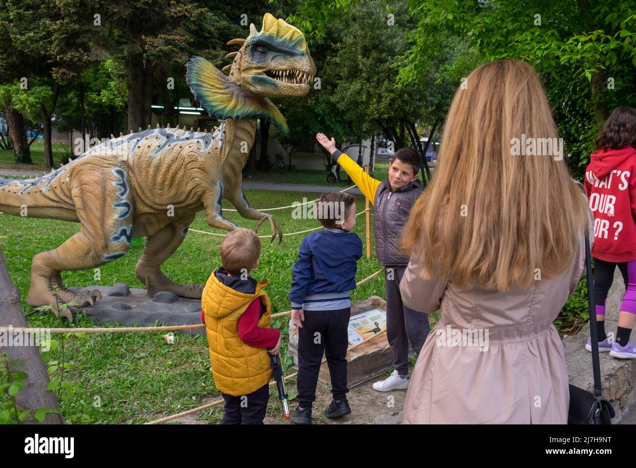 Parents with their kids staring the dinosaurs on the dinosaur festival ...