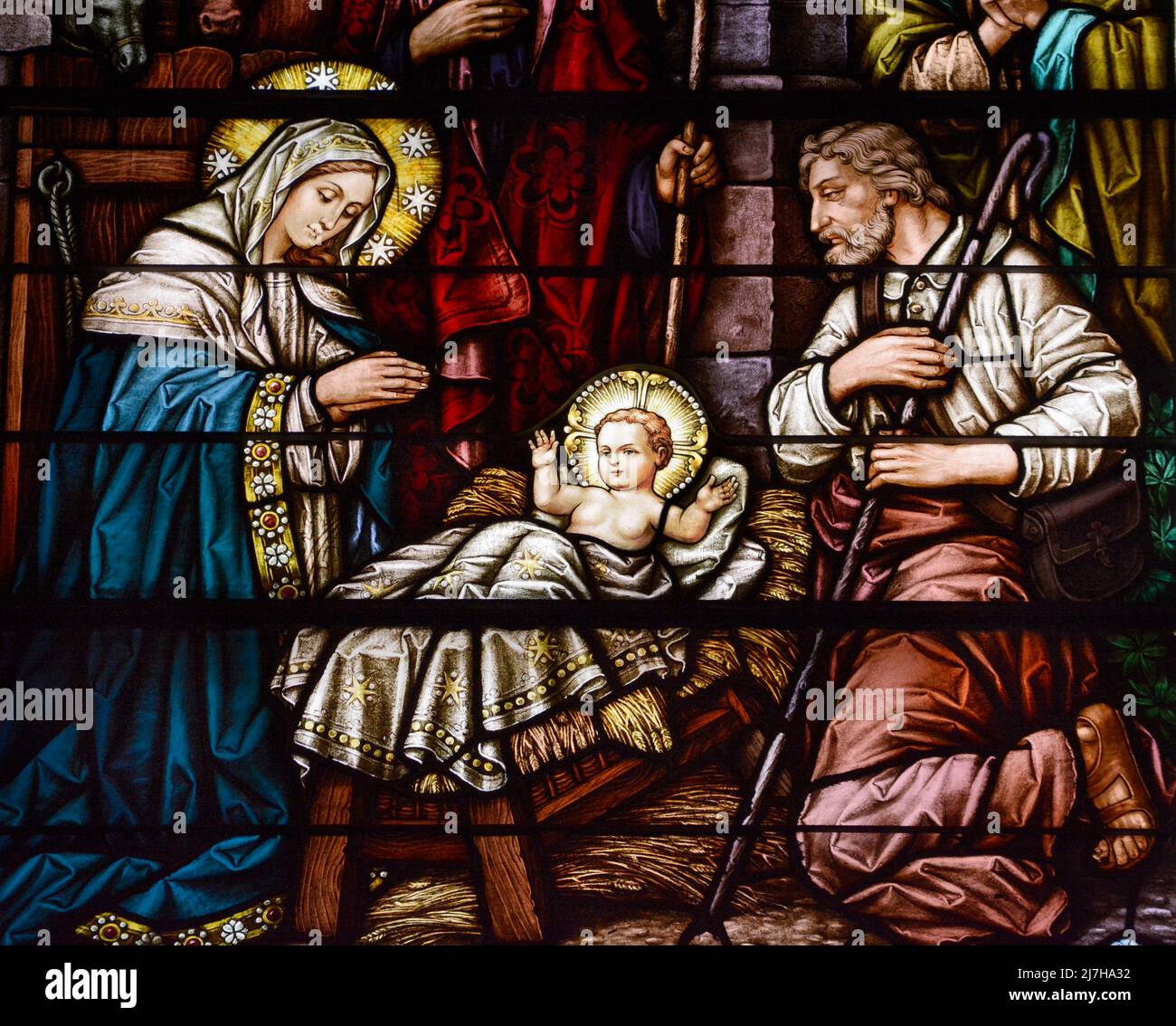 A stained glass window portraying the Nativity Scene in Saints Peter and Paul Catholic Church in ...