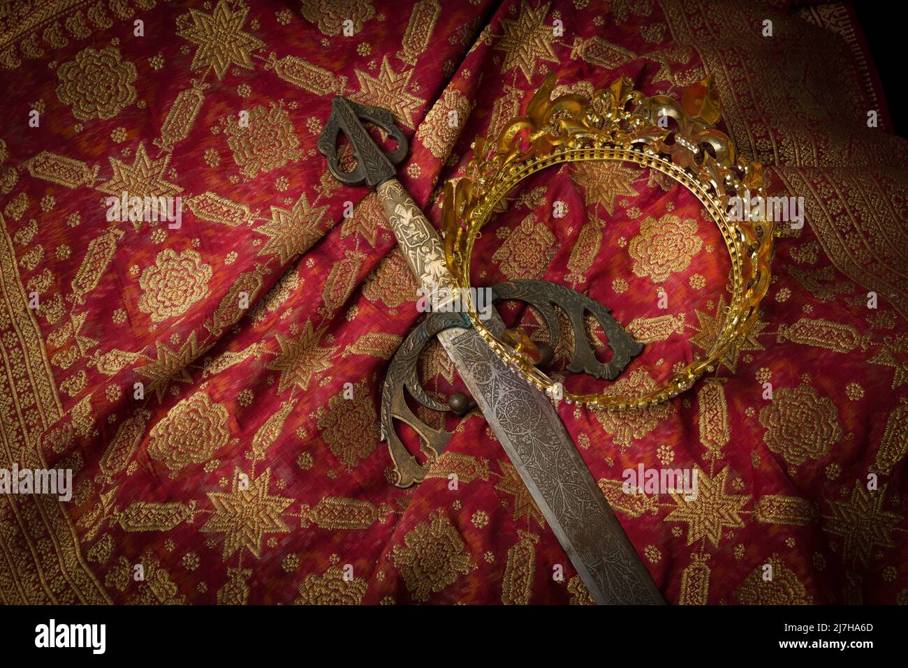 Golden king's crown and brass conquistador sword. This is a Spanish ...