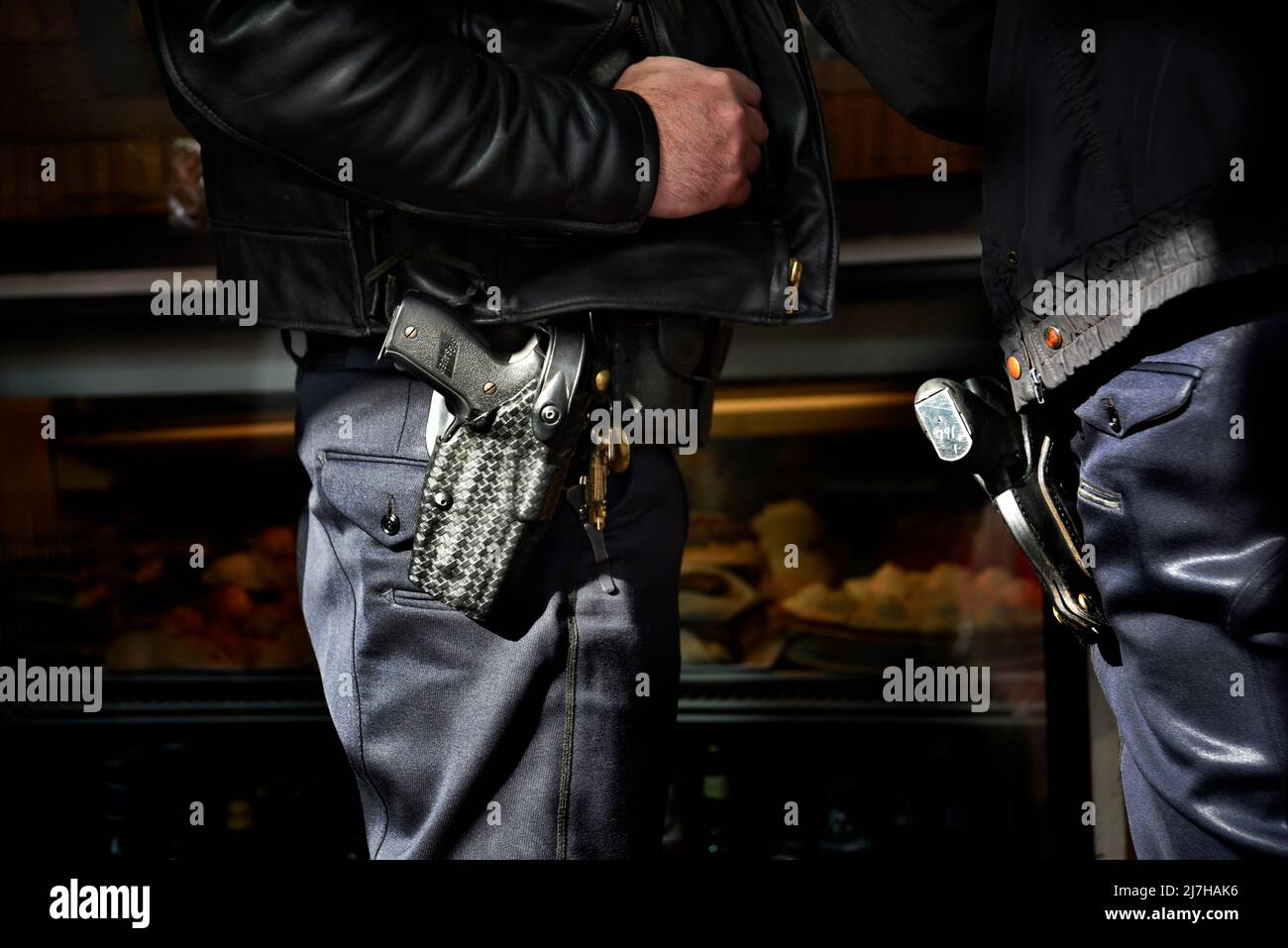 Two police officers stand in line to purchase coffee at a cafe in the ...