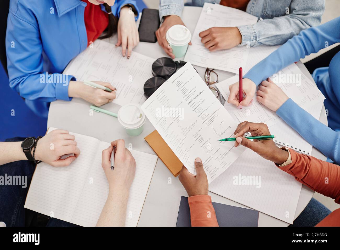 Top view of table with notebooks and documents busy group of college ...