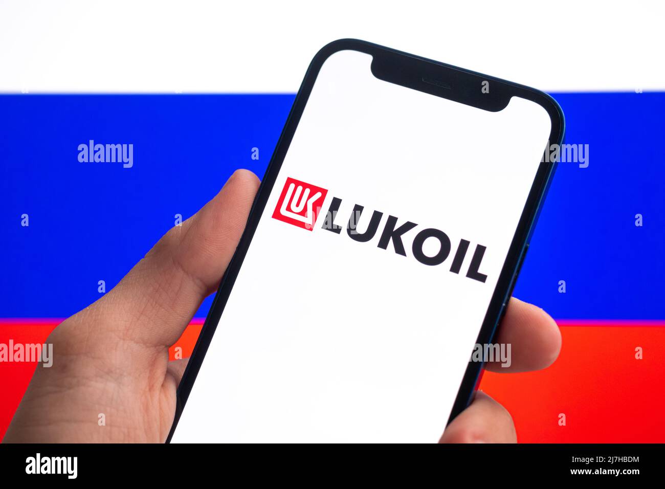 Lukoil russian oil and gas logo close-up, background of russian flag ...
