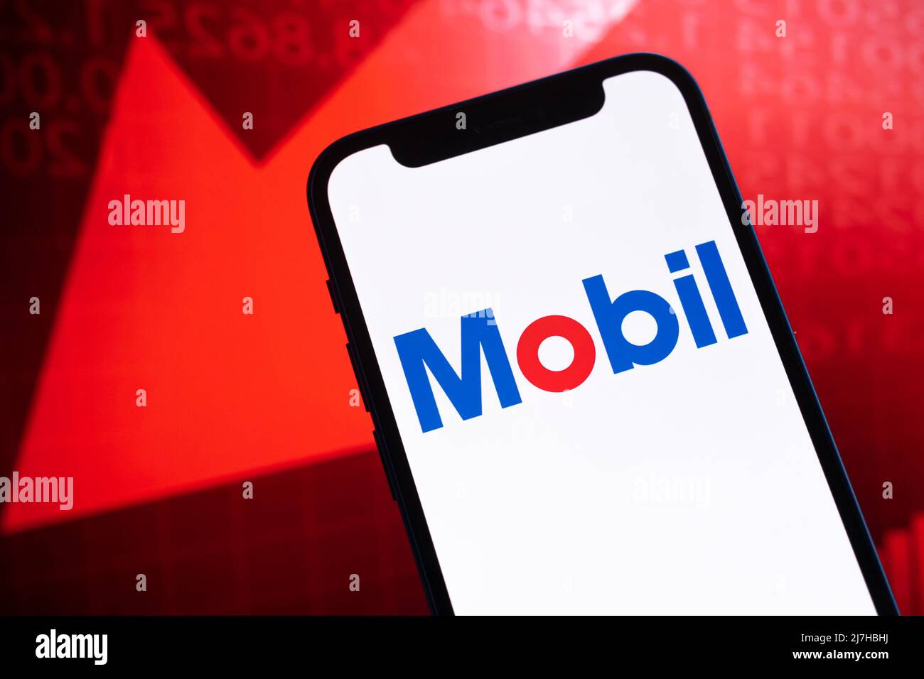 Mobil oil prices, logo close-up. Collapse, petroleum crisis, red arrow ...