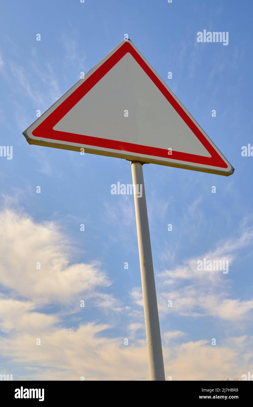 Traffic warning sign background clouds and blue sky Stock Photo - Alamy