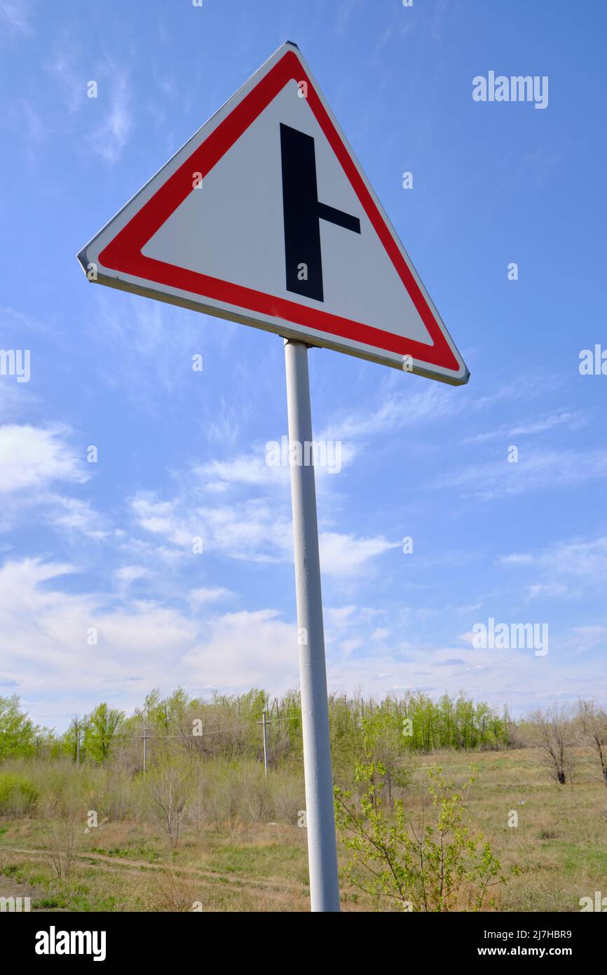 Road sign warning turn from main road blue sky background Stock Photo ...