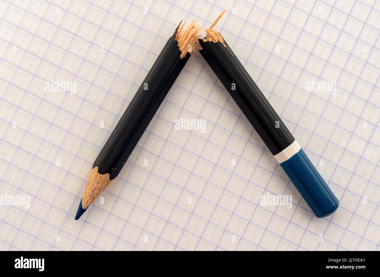 Broken pencil on white checkered paper close-up. cracked pencil Stock ...