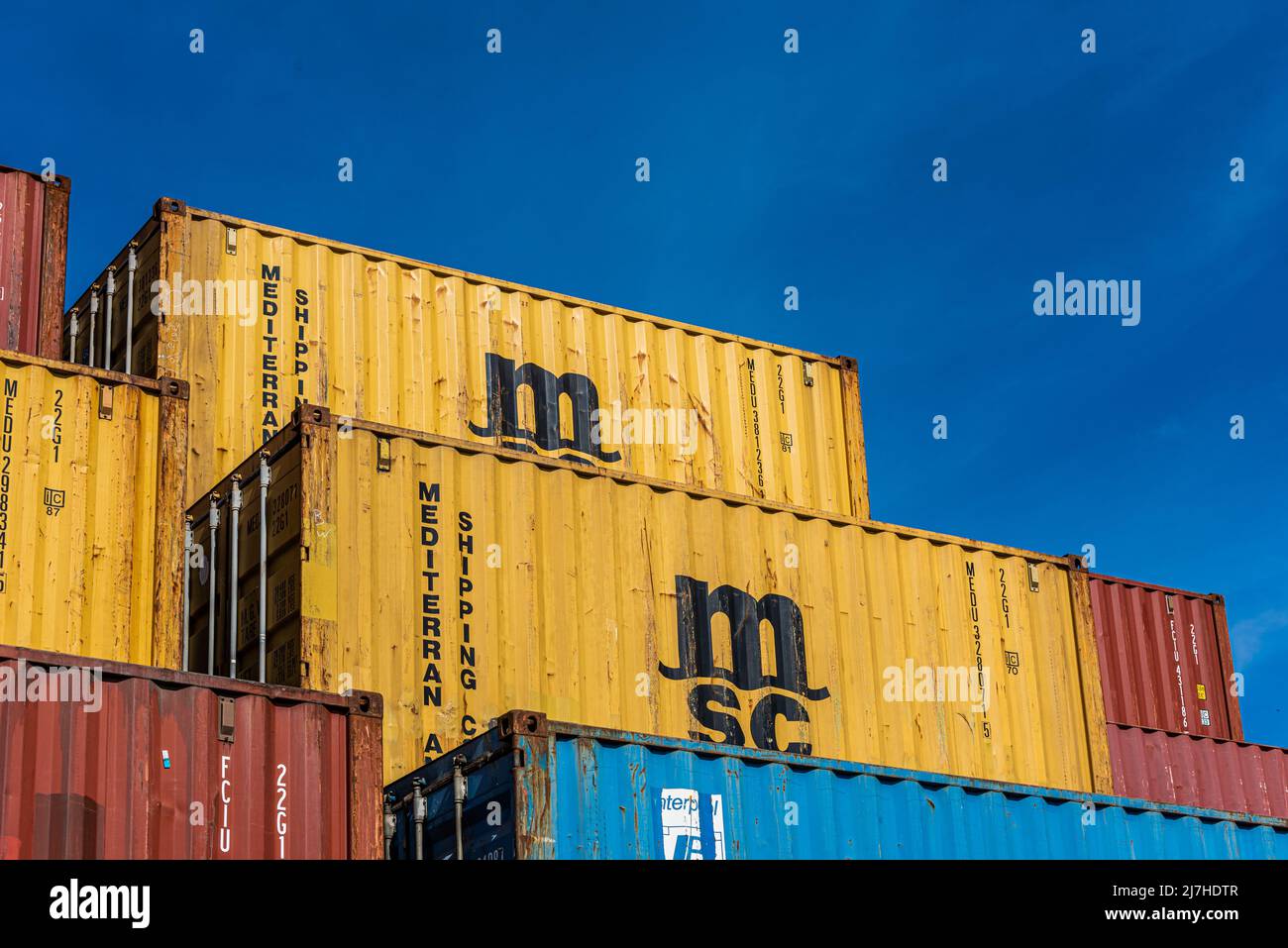 Yellow MSC shipping containers stacked high Stock Photo - Alamy