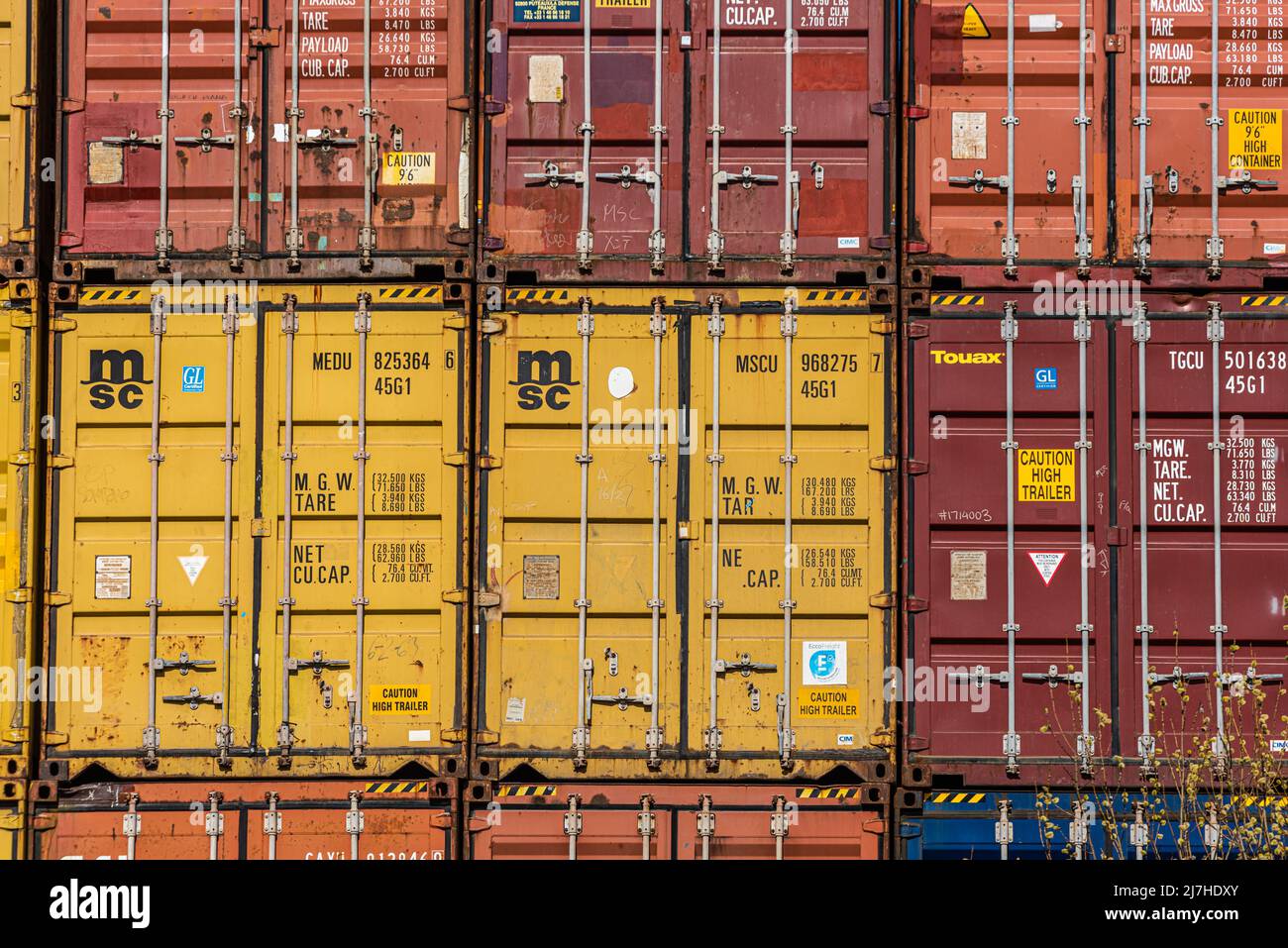 Shipping containers stacked high Stock Photo - Alamy