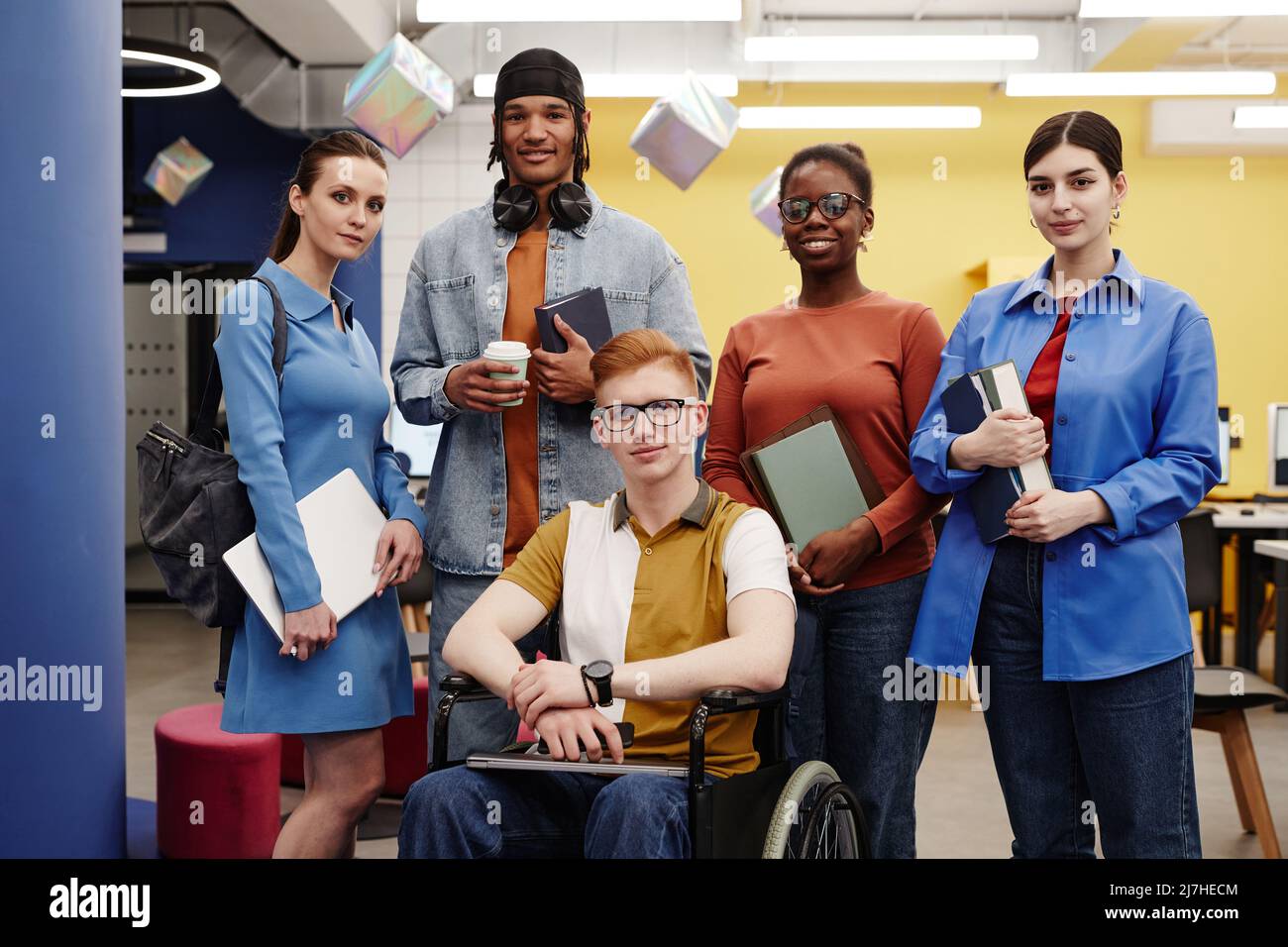 Vibrant portrait of diverse group of students in college young man with ...