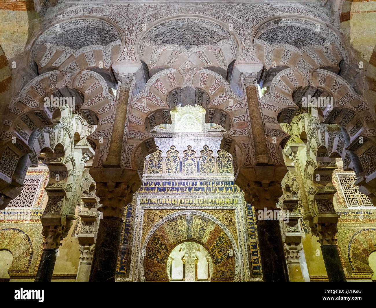 The mosaic-decorated mihrab (center) and the interlacing arches of the ...