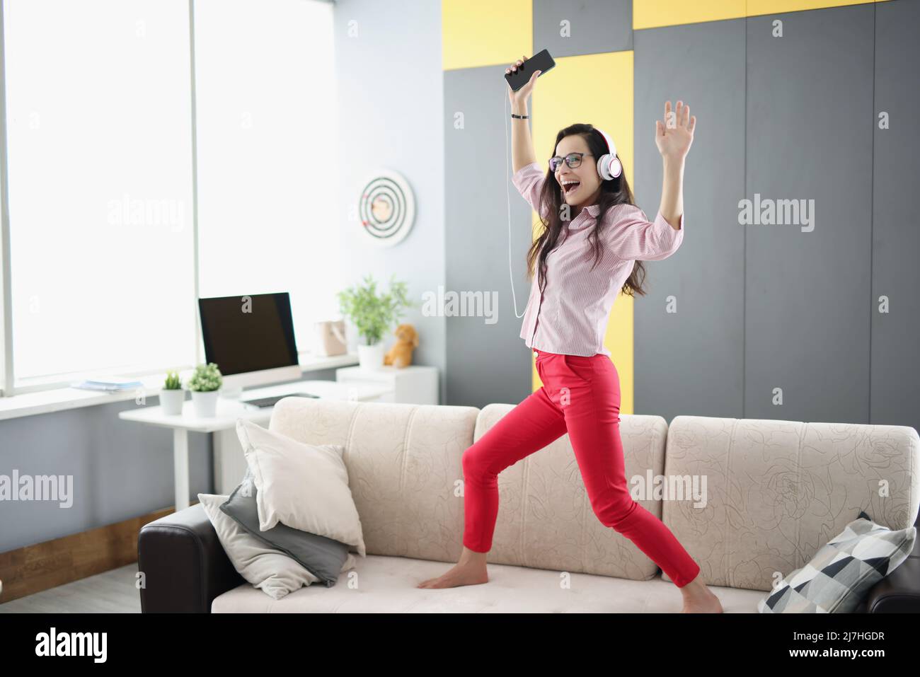 Woman dancing on couch hi-res stock photography and images - Alamy