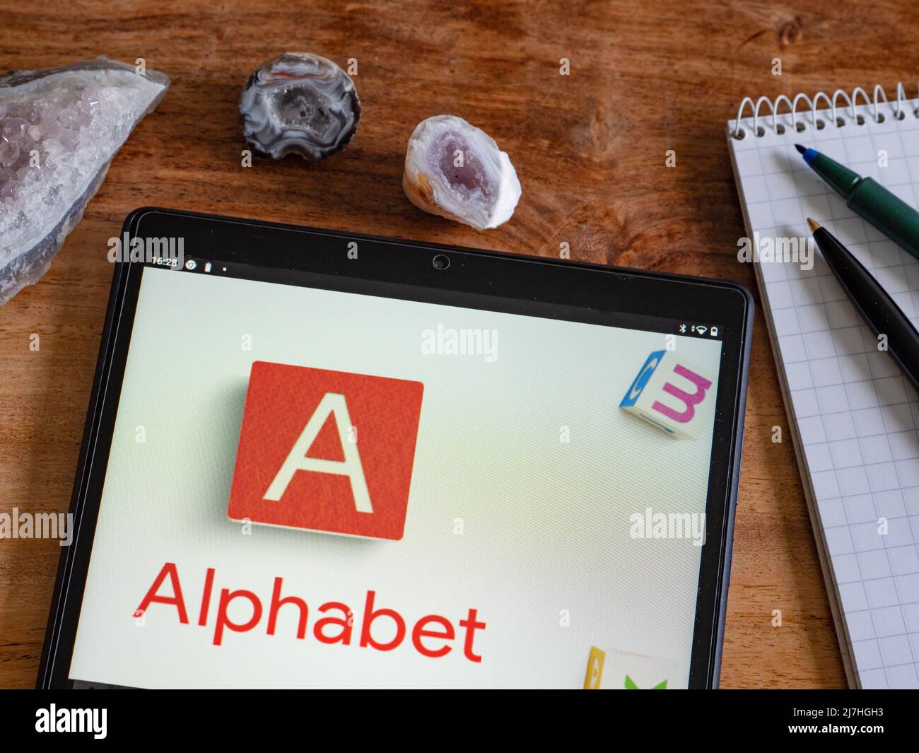 In this photo illustration Alphabet Inc. logo seen displayed on a ...