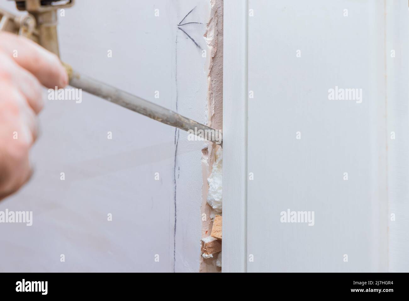 Handyman installing door with an mounting foam in a room Stock Photo ...