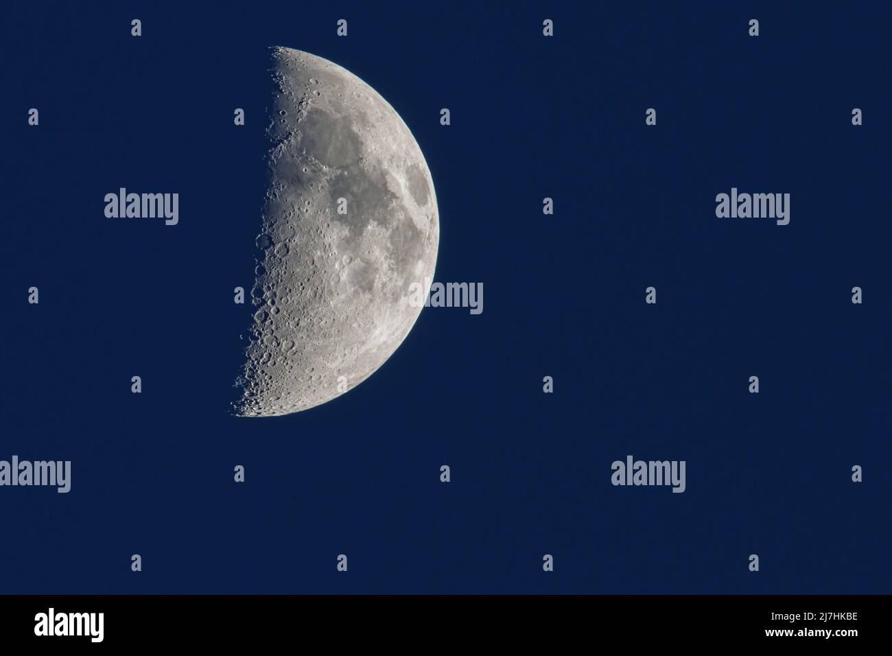 a close up of the waxing crescent moon in the blue sky Stock Photo - Alamy