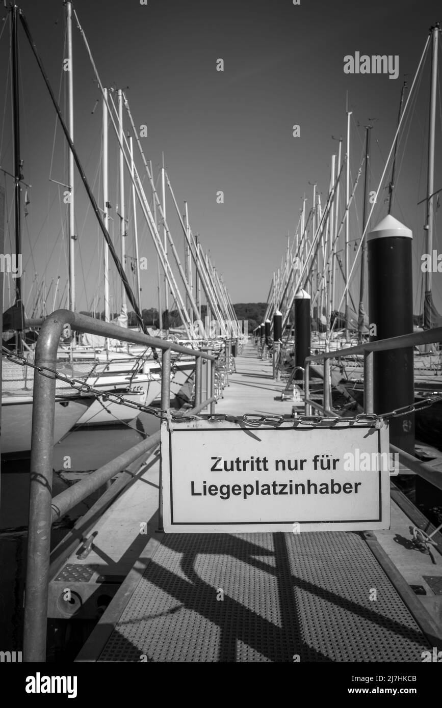 a sign on a jetty says access only for berth holders Stock Photo - Alamy