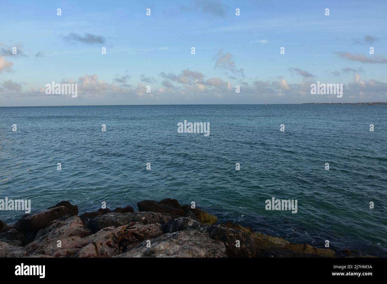 Very low clouds hovering just over the ocean off the shore of Aruba ...