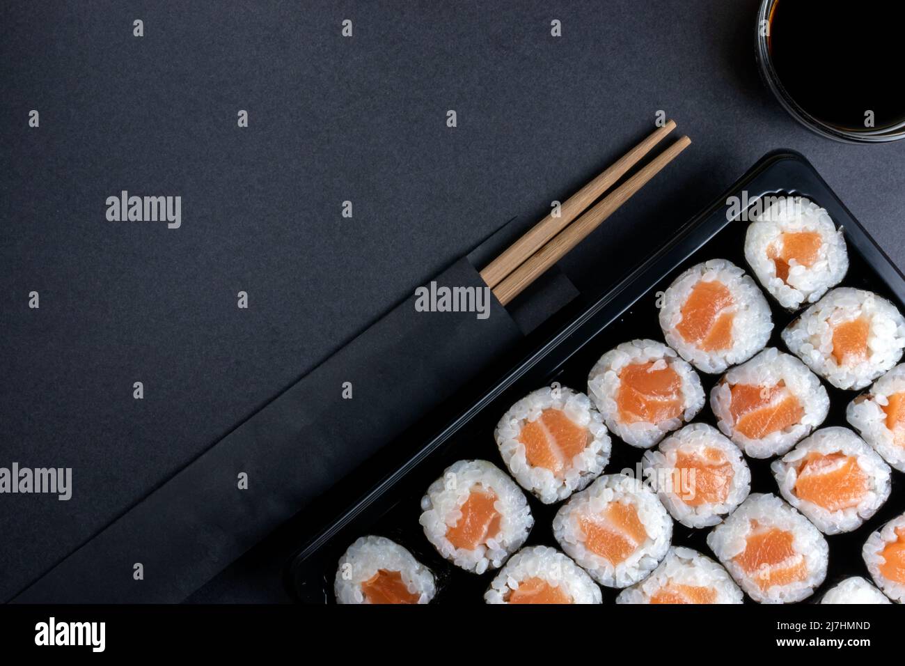 Salmon maki roll on black dark background. Asian traditional salmon ...