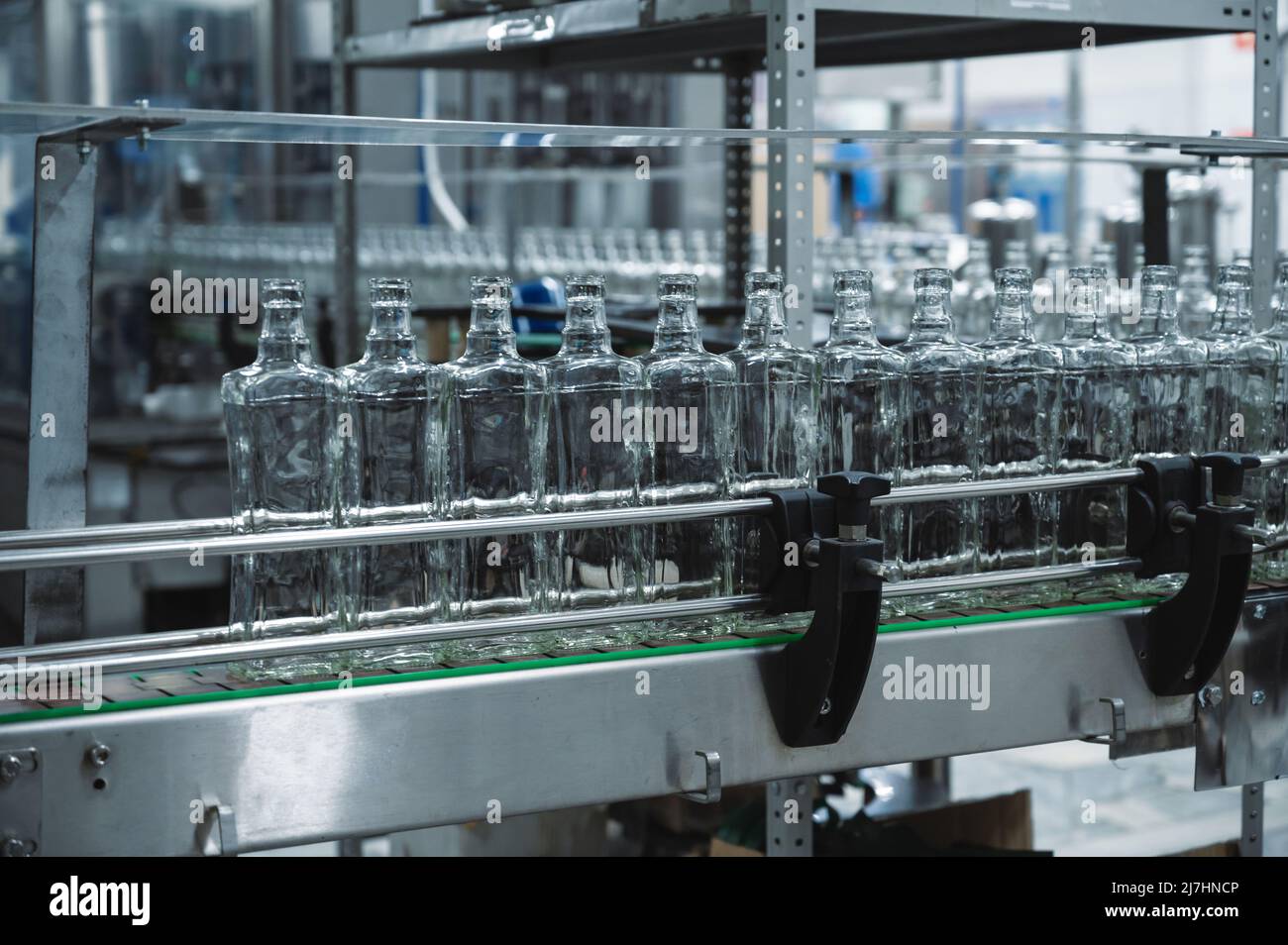 Production line transports empty glass bottles for alcohol Stock Photo ...