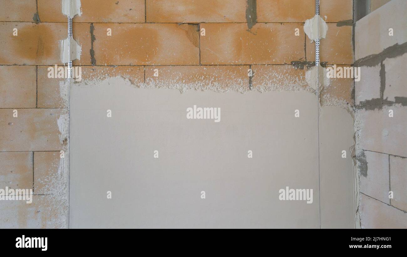 Fastening metal strips to the wall. Wall repair. Construction work and ...