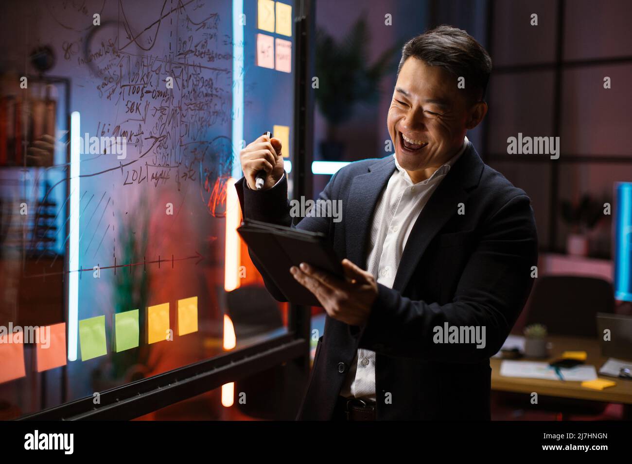 Brainstorming, success concept. Happy excited Asian businessman ...