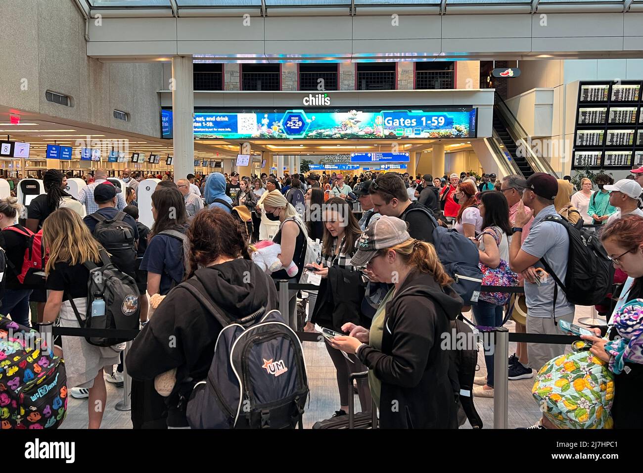 Passengers stand in a TSA screening line at the Orlando International ...