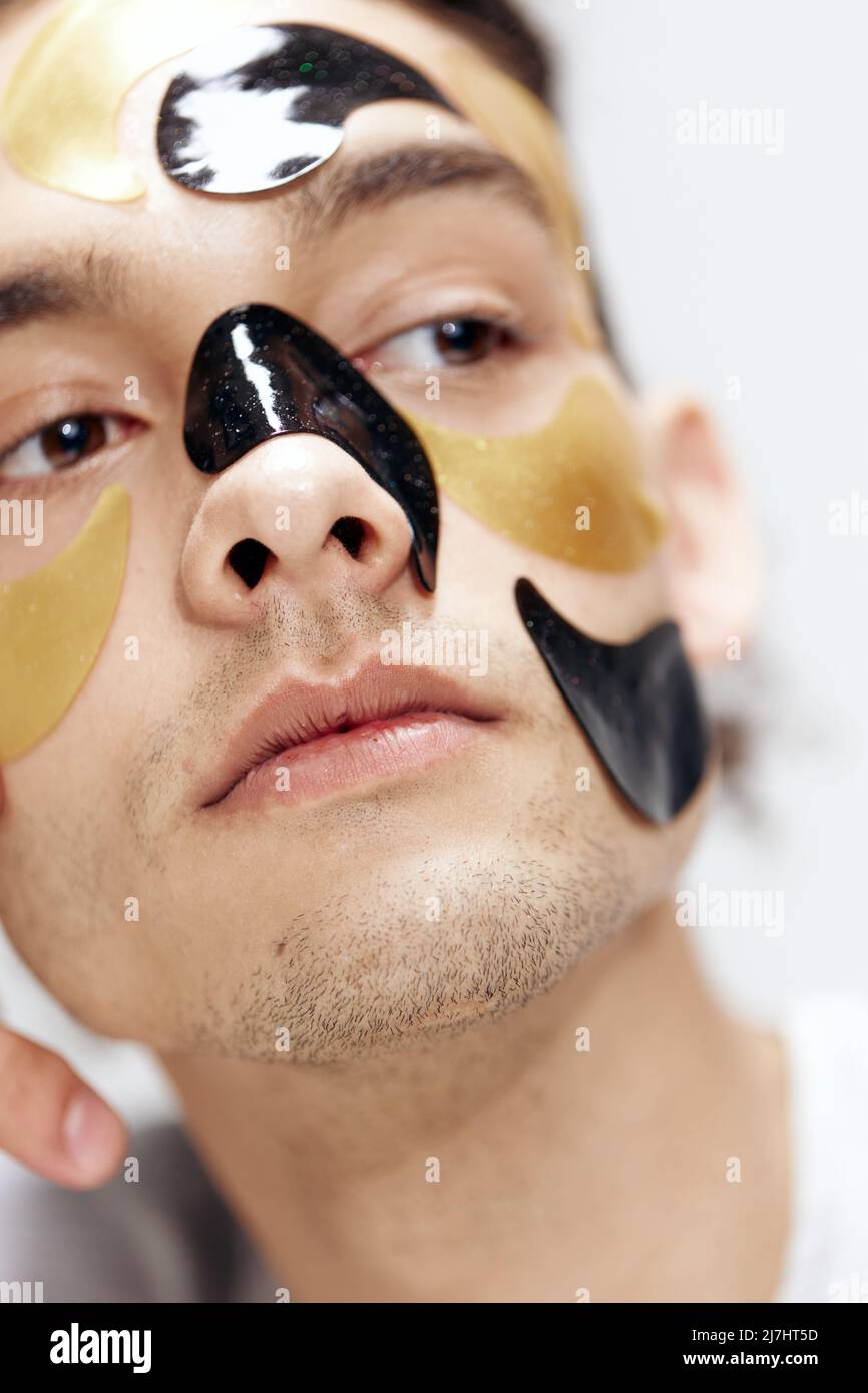 guy with curly hair black and gold patches on the face health ...