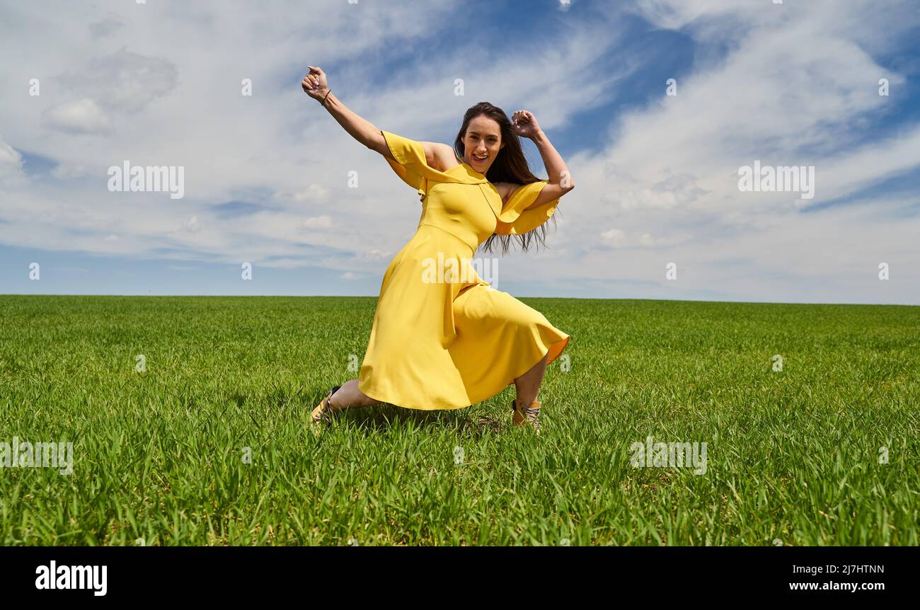 Funny young woman making silly moves outdoor on a green pasture Stock ...