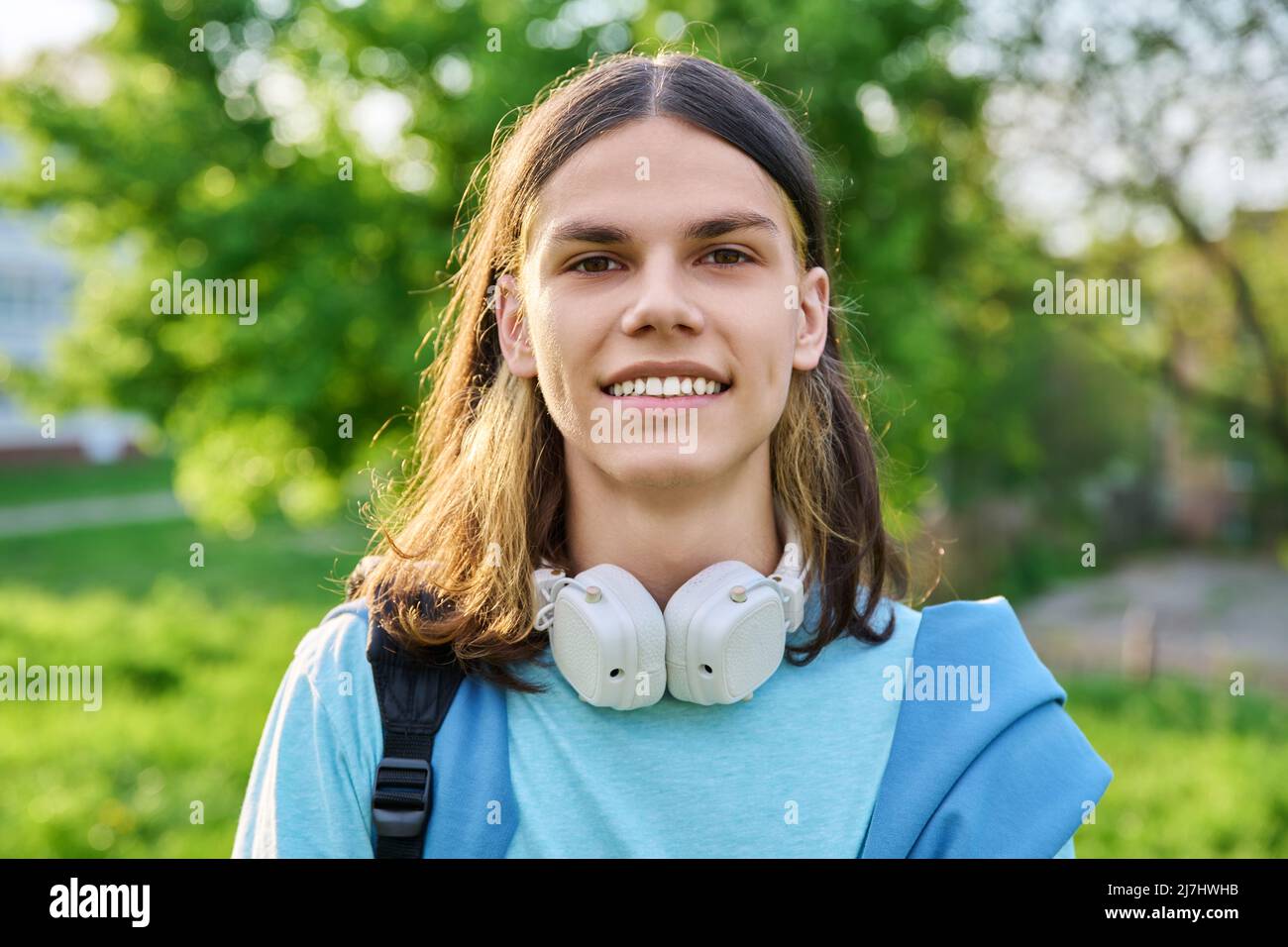 Outdoor portrait of handsome student guy with backpack looking at ...