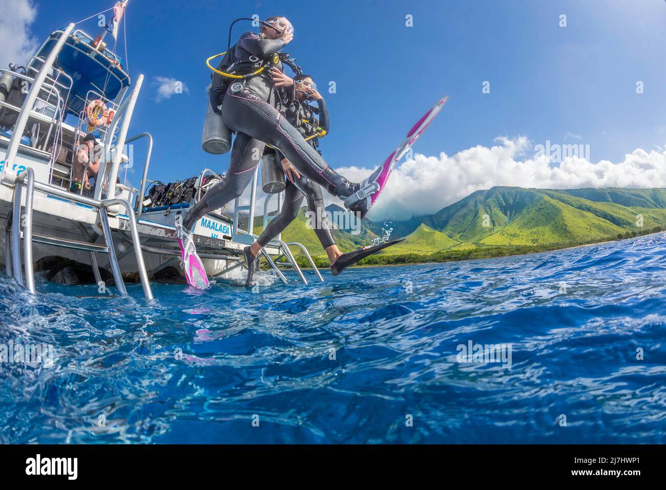 Divers (MR) step off a dive boat into the Pacific Ocean out from ...