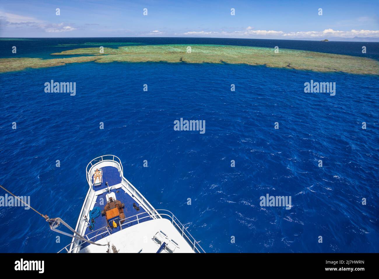The live-aboard dive boat, Nai'a, anchored off a pinnacle in open ocean ...