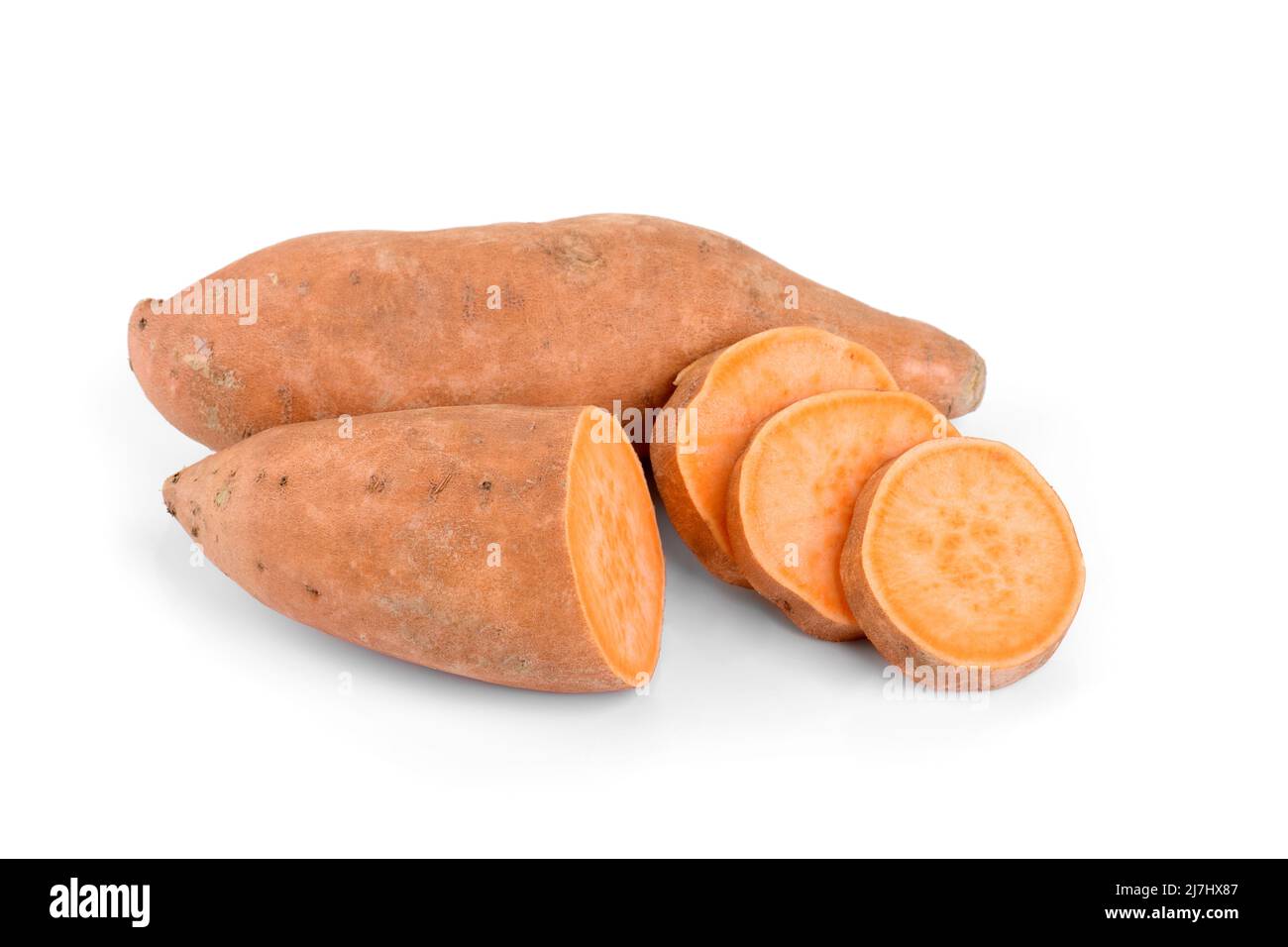 Raw whole orange sweet potato and slices of batatas isolated on white ...