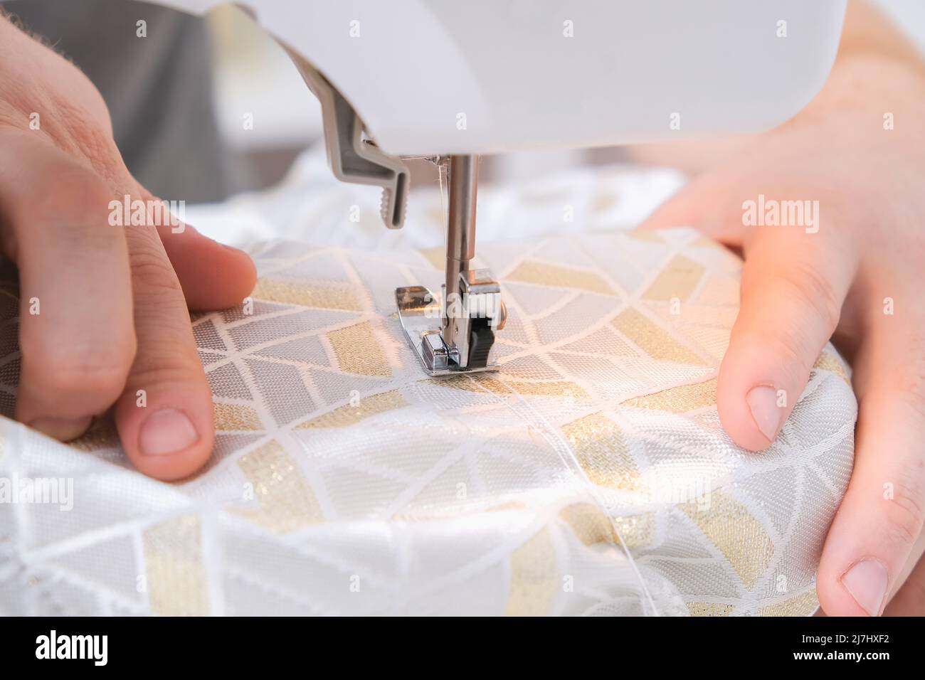 A man sews clothes on a sewing machine. Hobbies, needlework, creativity ...