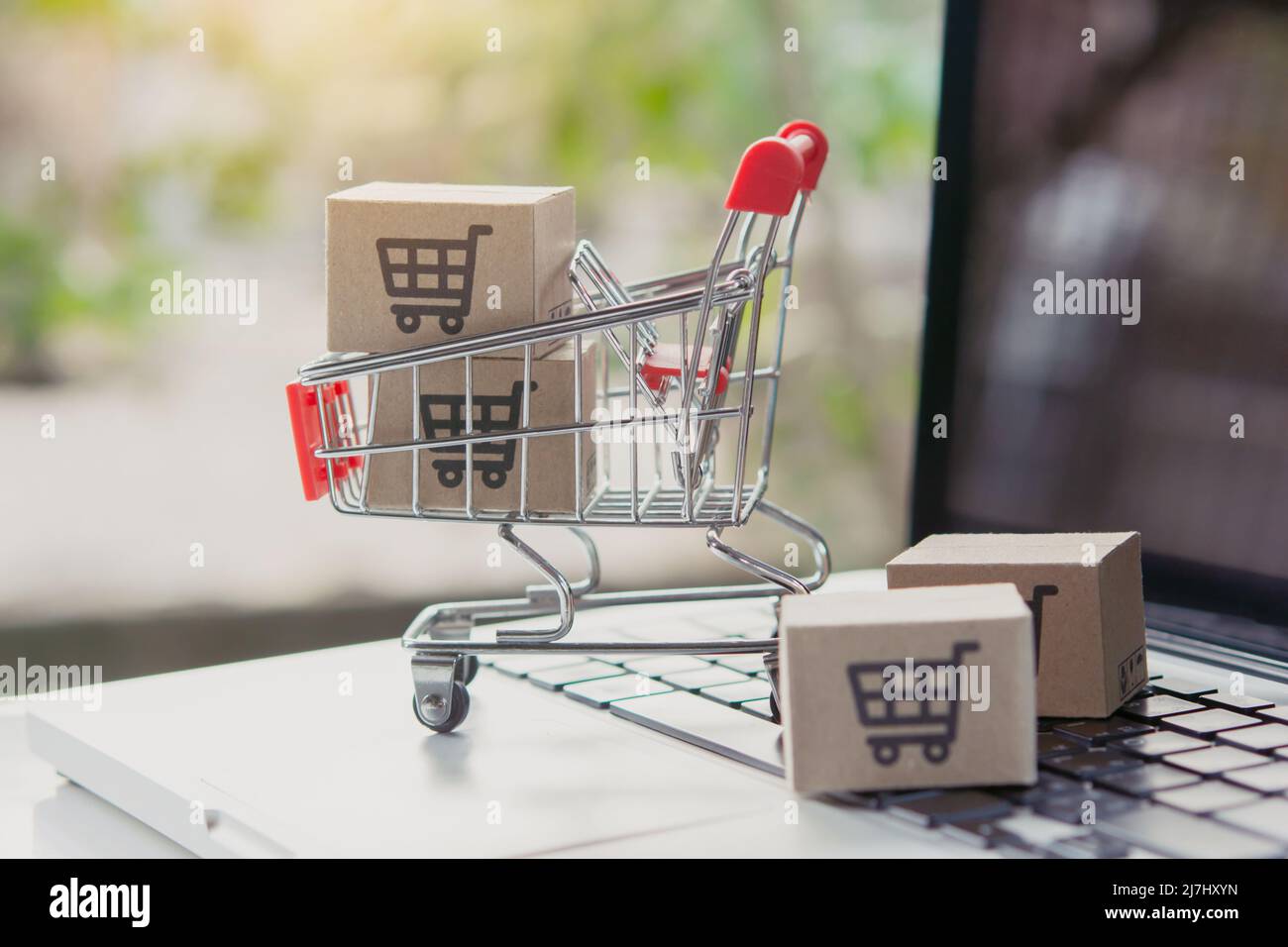 Shopping online. Cardboard box with a shopping cart logo in a trolley ...