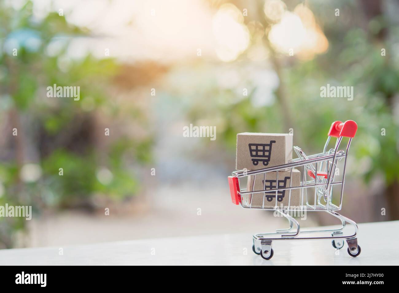 Shopping concept : Cartons or Paper boxes in red shopping cart on white ...