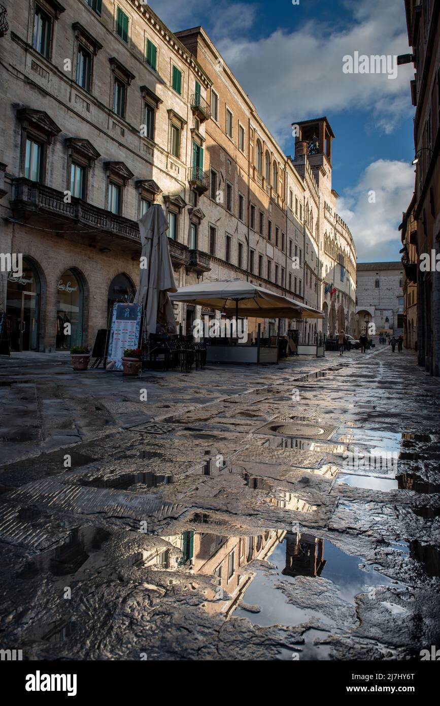 Ancient part of Perugia which is reflected in the puddle after the rain ...