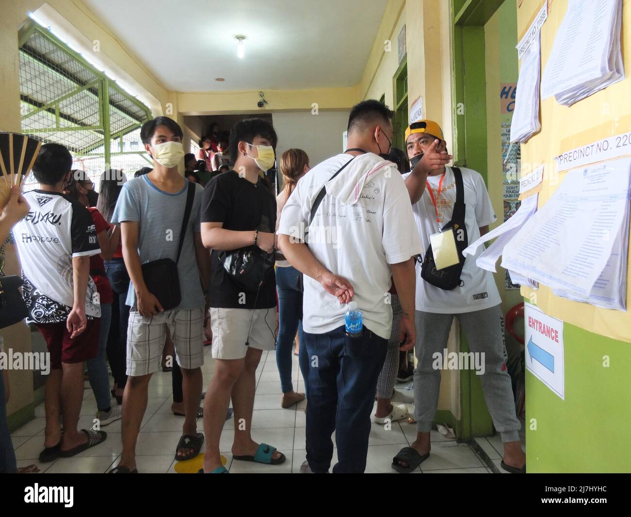 A Comelec officer seen guiding voters on which room they are designated ...