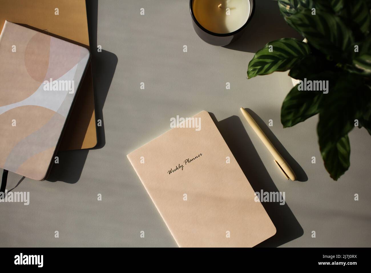 Aesthetic feminine workspace with weekly planner, notebooks, pen ...