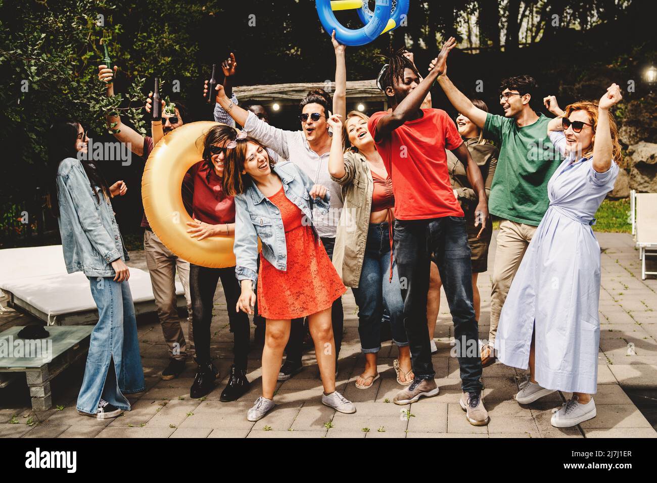 Happy diverse people dancing carefree at spring break party outdoor ...