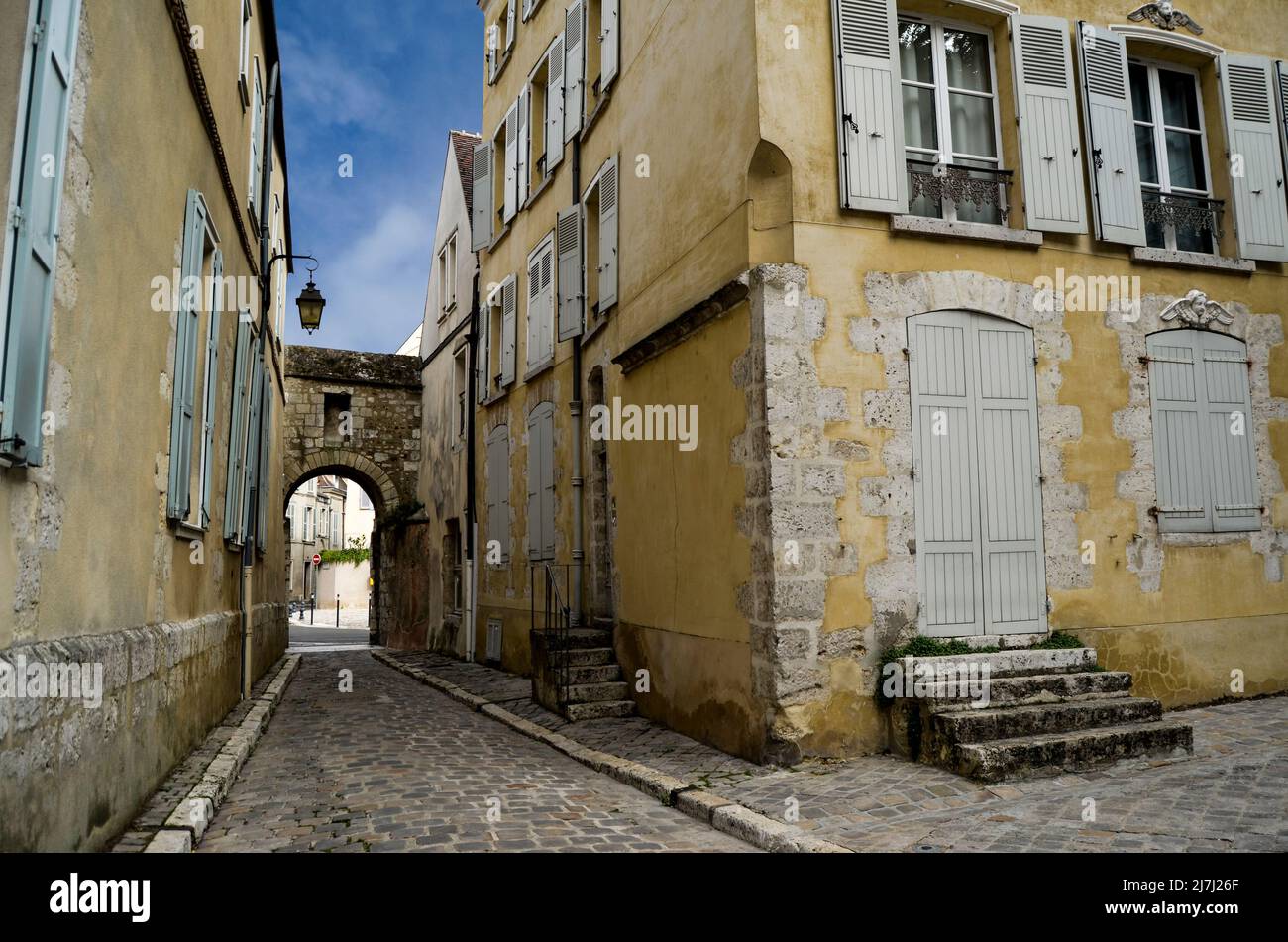 Side Street in Chartres, France, with archway, homes, and stairs Stock ...
