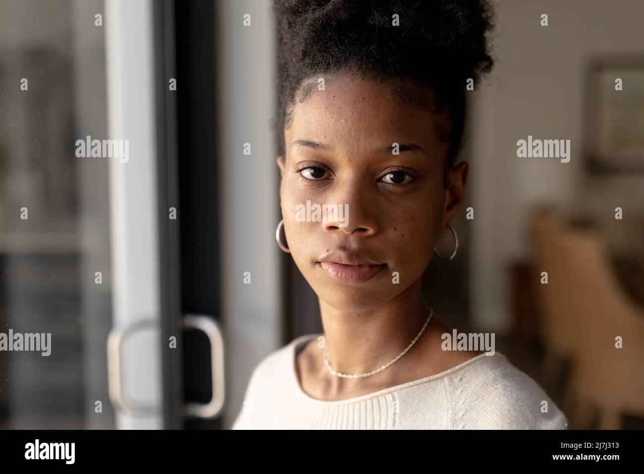 Young woman interior serious hi-res stock photography and images - Alamy