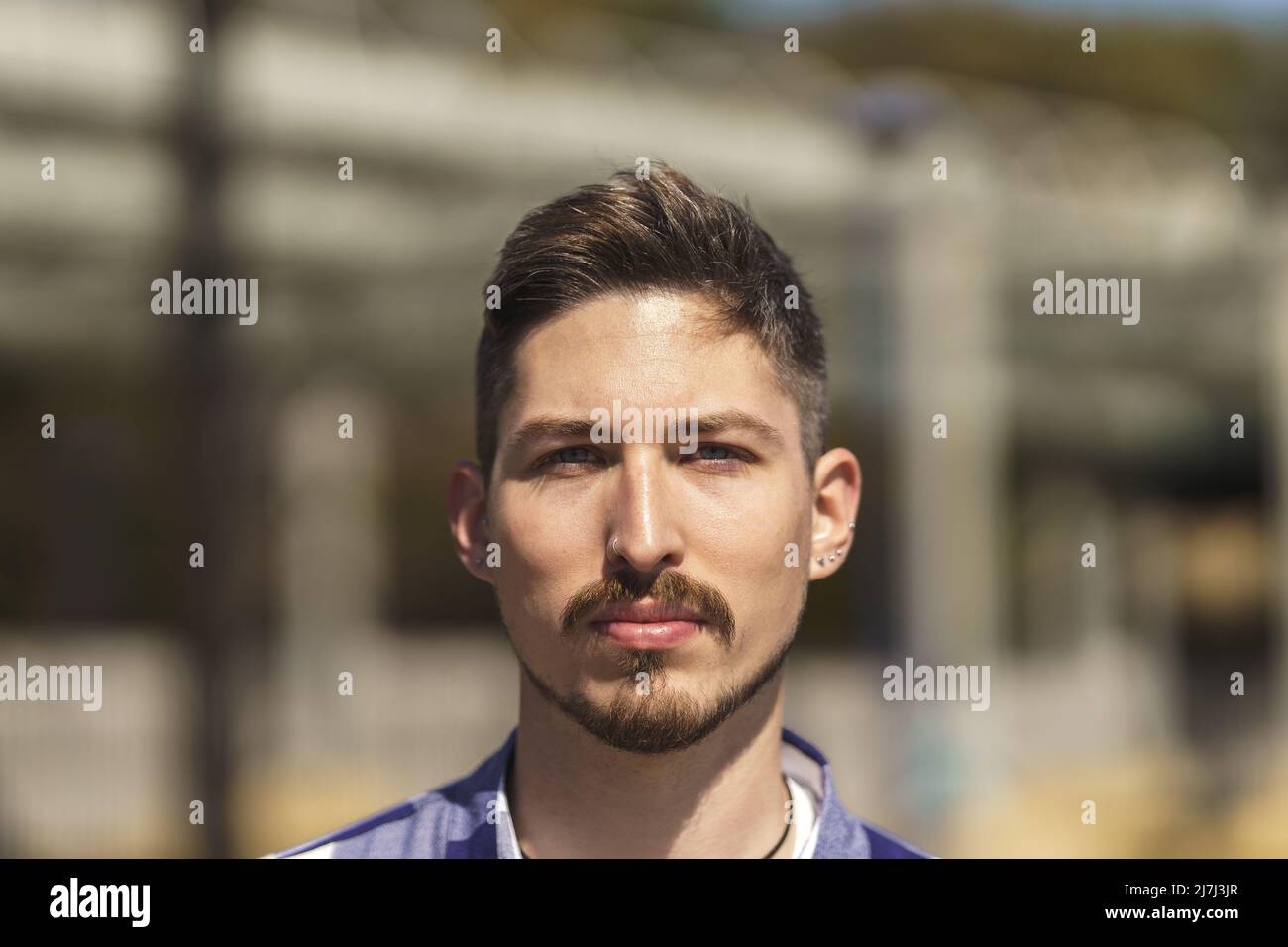 portrait of young white man with beard, piercings and blue eyes Stock ...