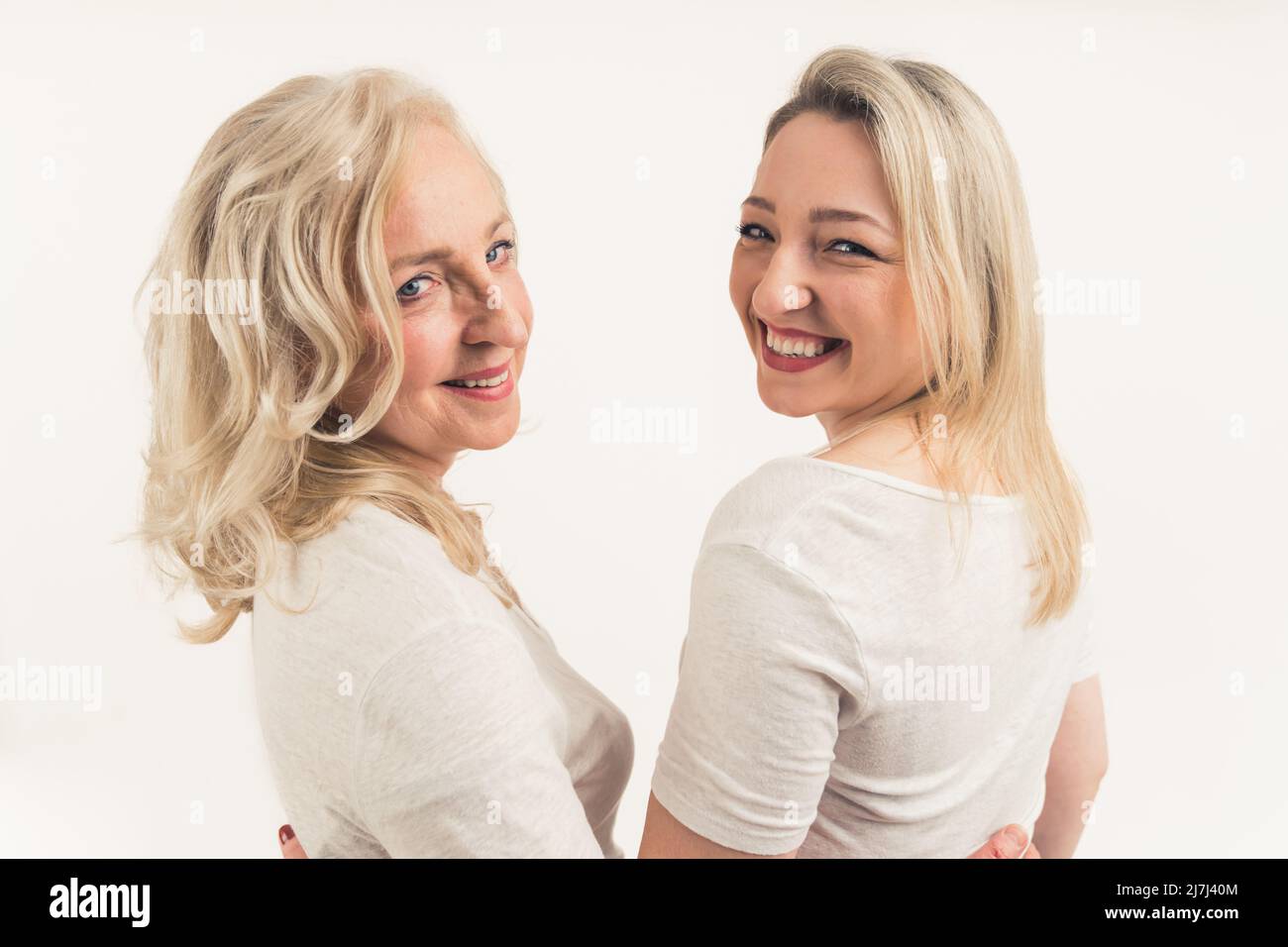 Beautiful aged woman embracing young adult lady and laughing, smiling ...