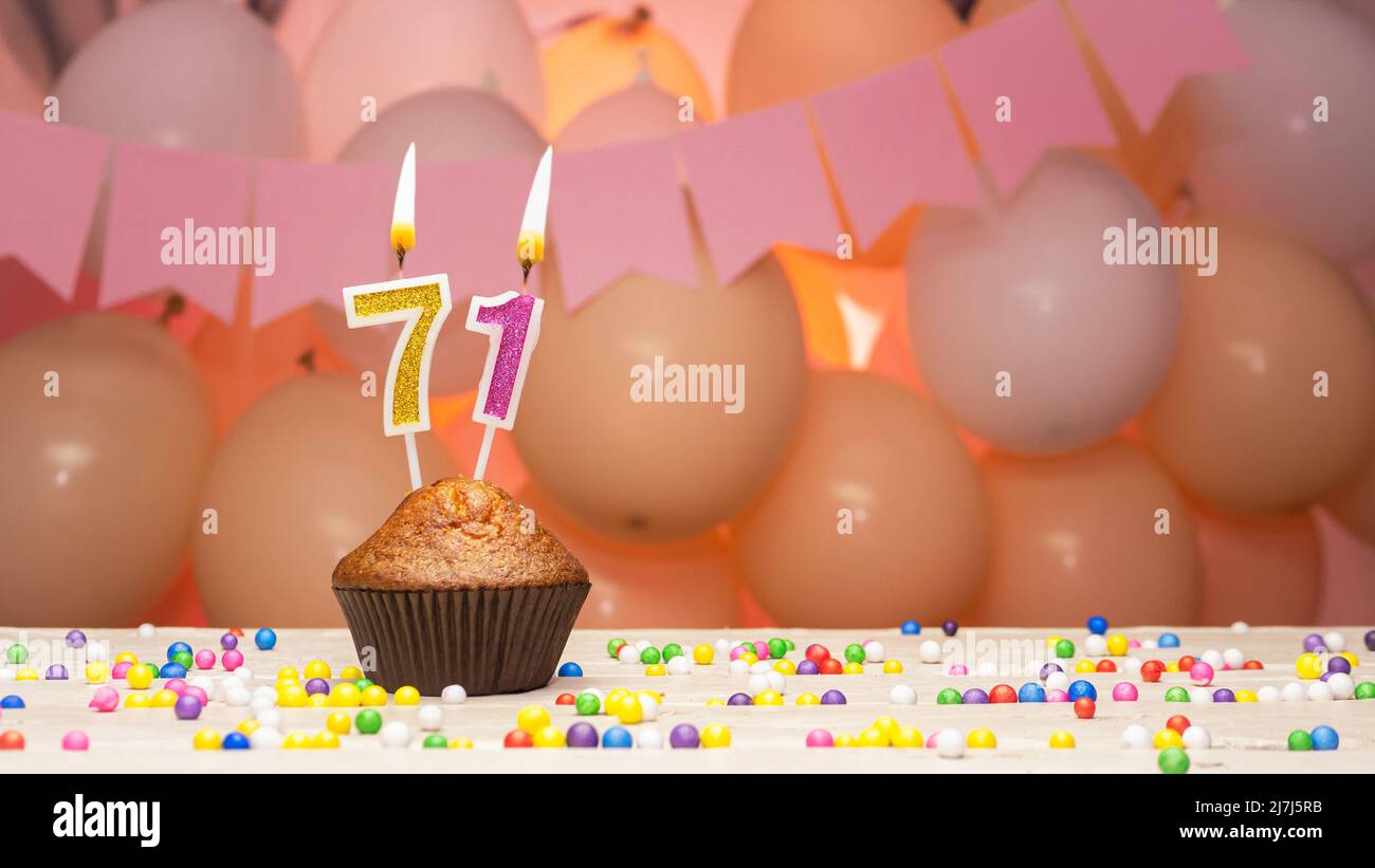 Balloon decorations and a happy birthday candle with a number in a cake ...