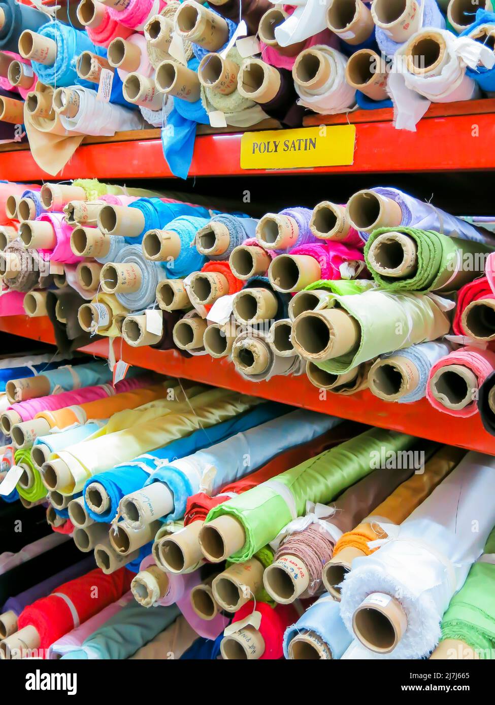 Rolls of Fabric on Store Shelves Ready for Purchase Stock Photo - Alamy