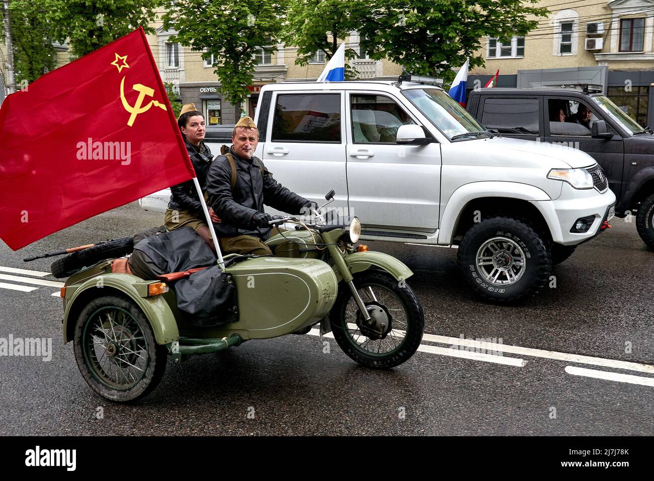 Participants of the rally seen on a motorcycle with the Soviet flag on ...