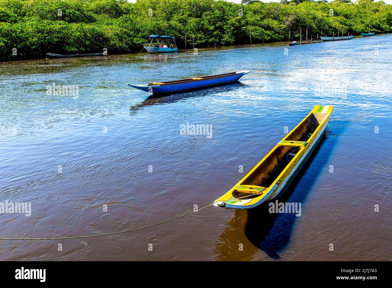 Two fishing canoes and a boat standing on the Jaguaripe River in ...