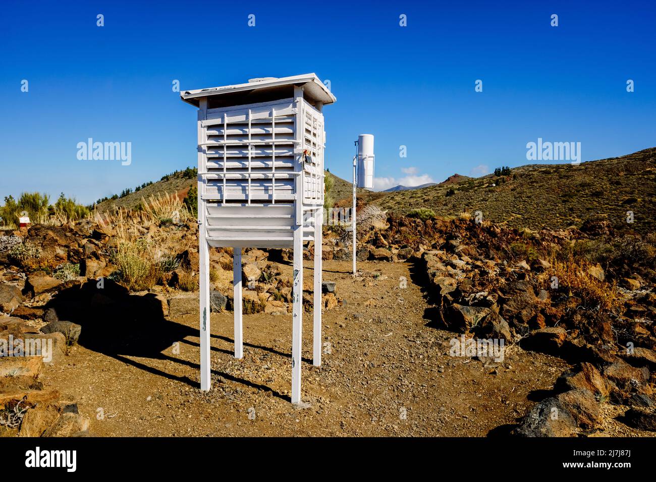 Climate measurement devices at a weather station on white wooden towers ...