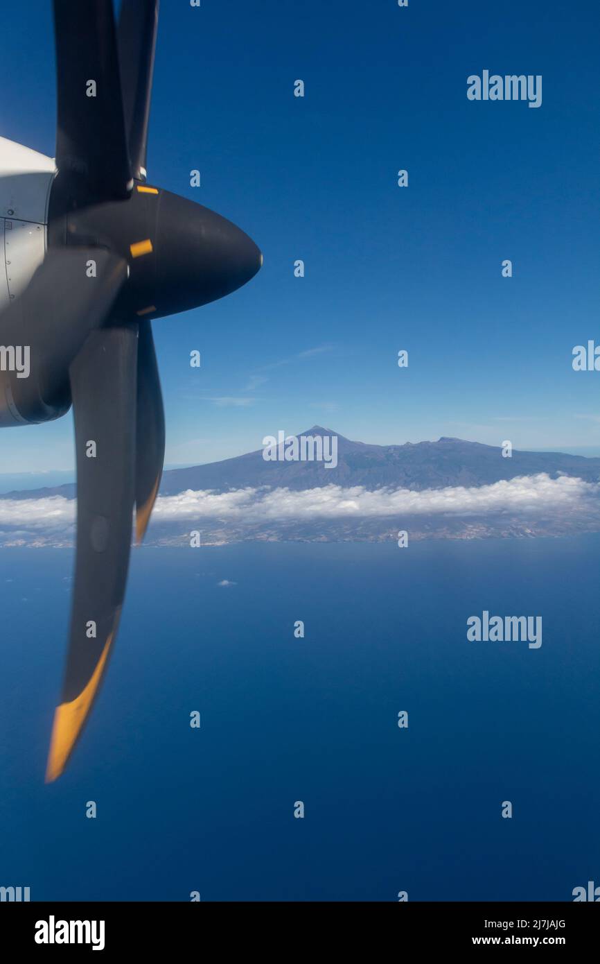 Flying propeller plane around Tenerife island with peak of Mount Teide ...