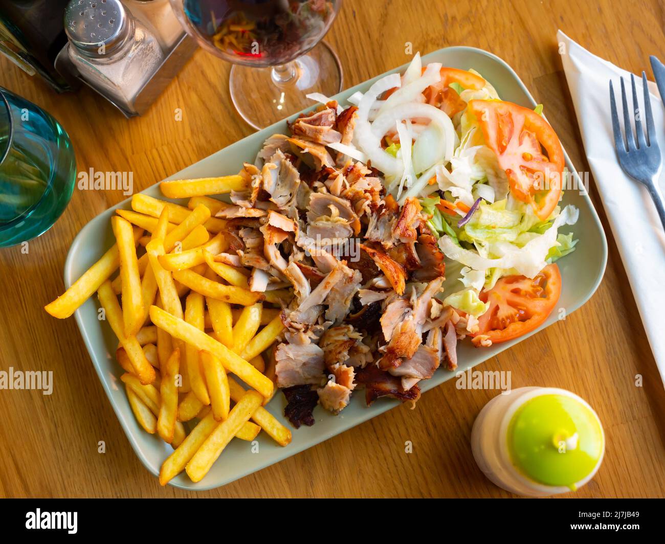 Dish Doner kebab with French fries and a light vegetable salad Stock ...